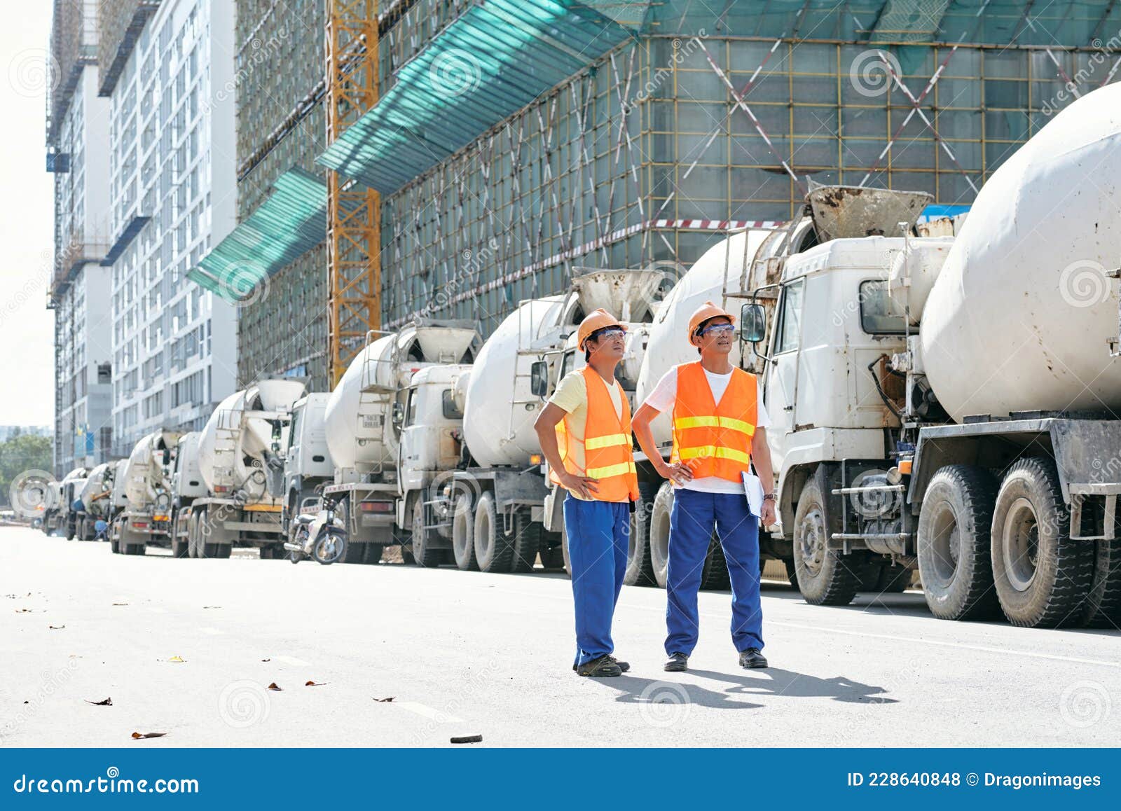 Construction Workers Standing at Parked Trucks Stock Photo - Image of ...