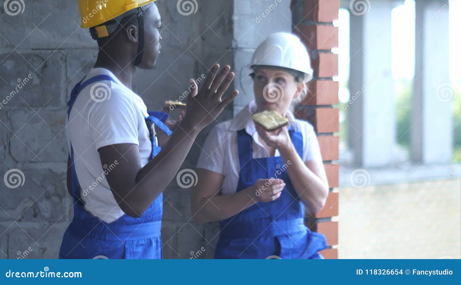 Construction Workers Take a Break Eating a Sandwich and Chatting Stock ...
