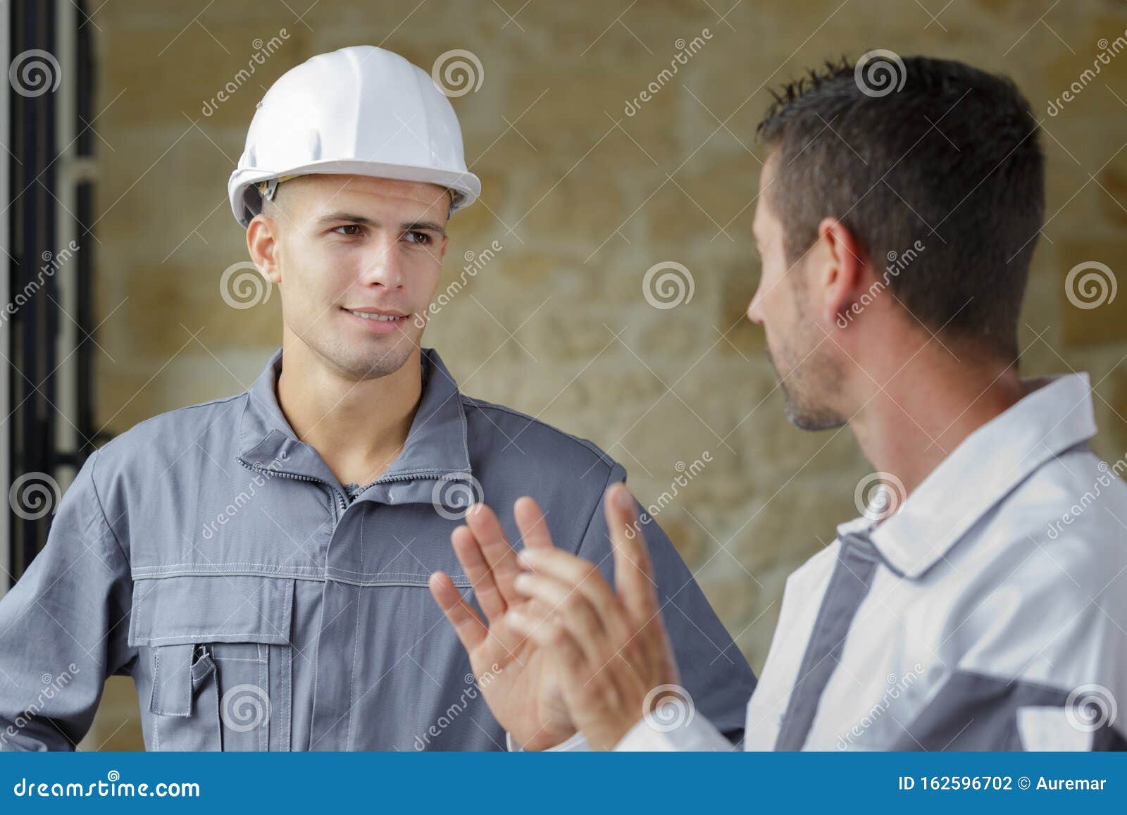 Construction Workers Talking in Construction Site Stock Photo - Image ...