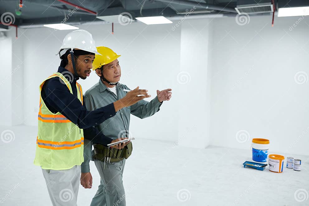 Construction Workers Talking at Site Stock Photo - Image of diverse ...