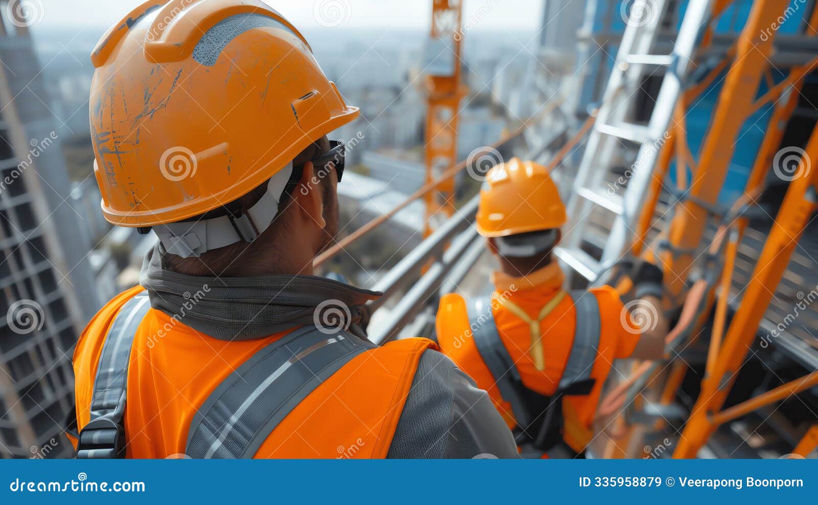 Construction Workers Using Fall Protection Systems on a High-rise ...