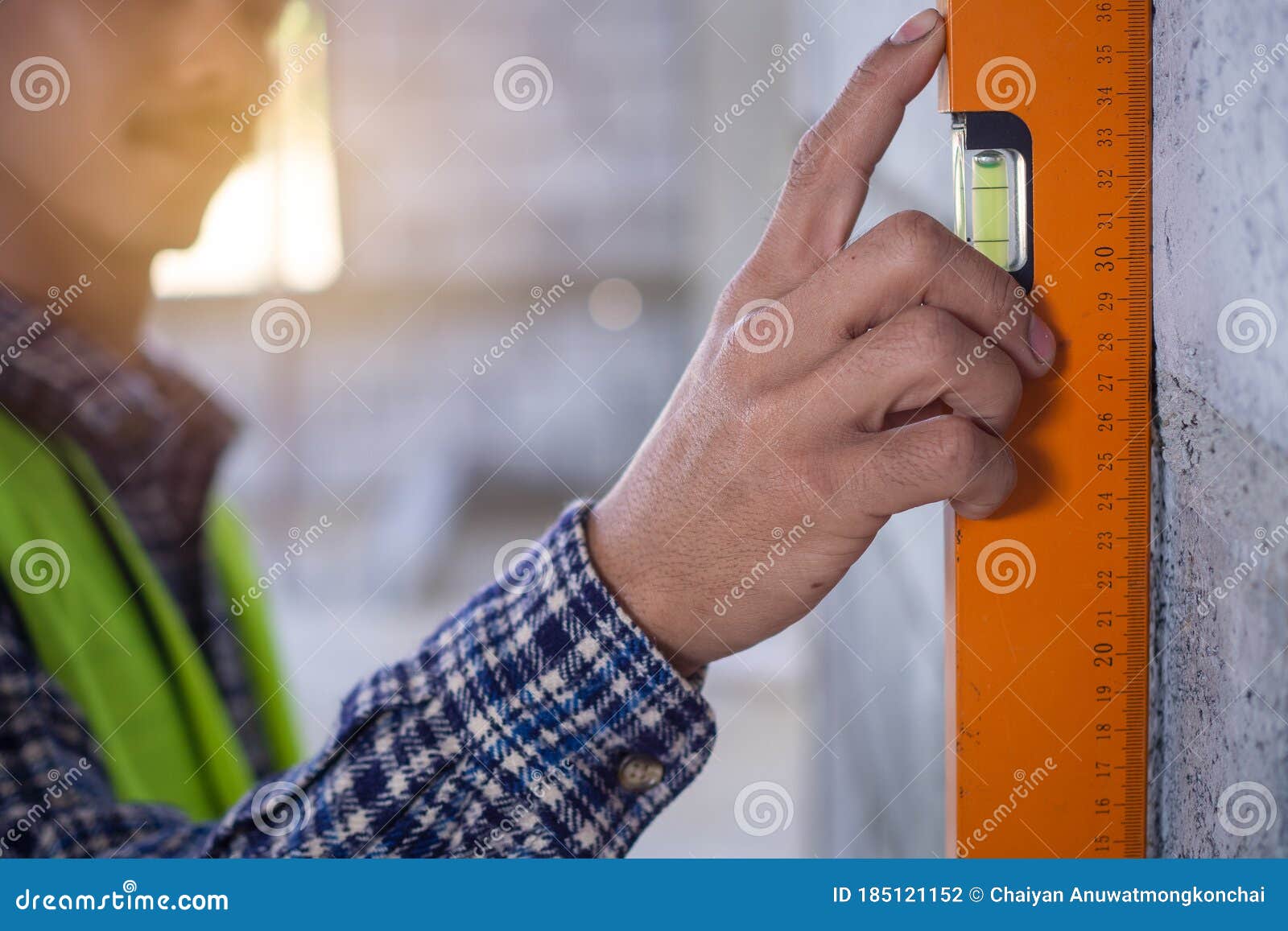 Construction Workers are Using Water Levels To Measure the Wall Stock ...