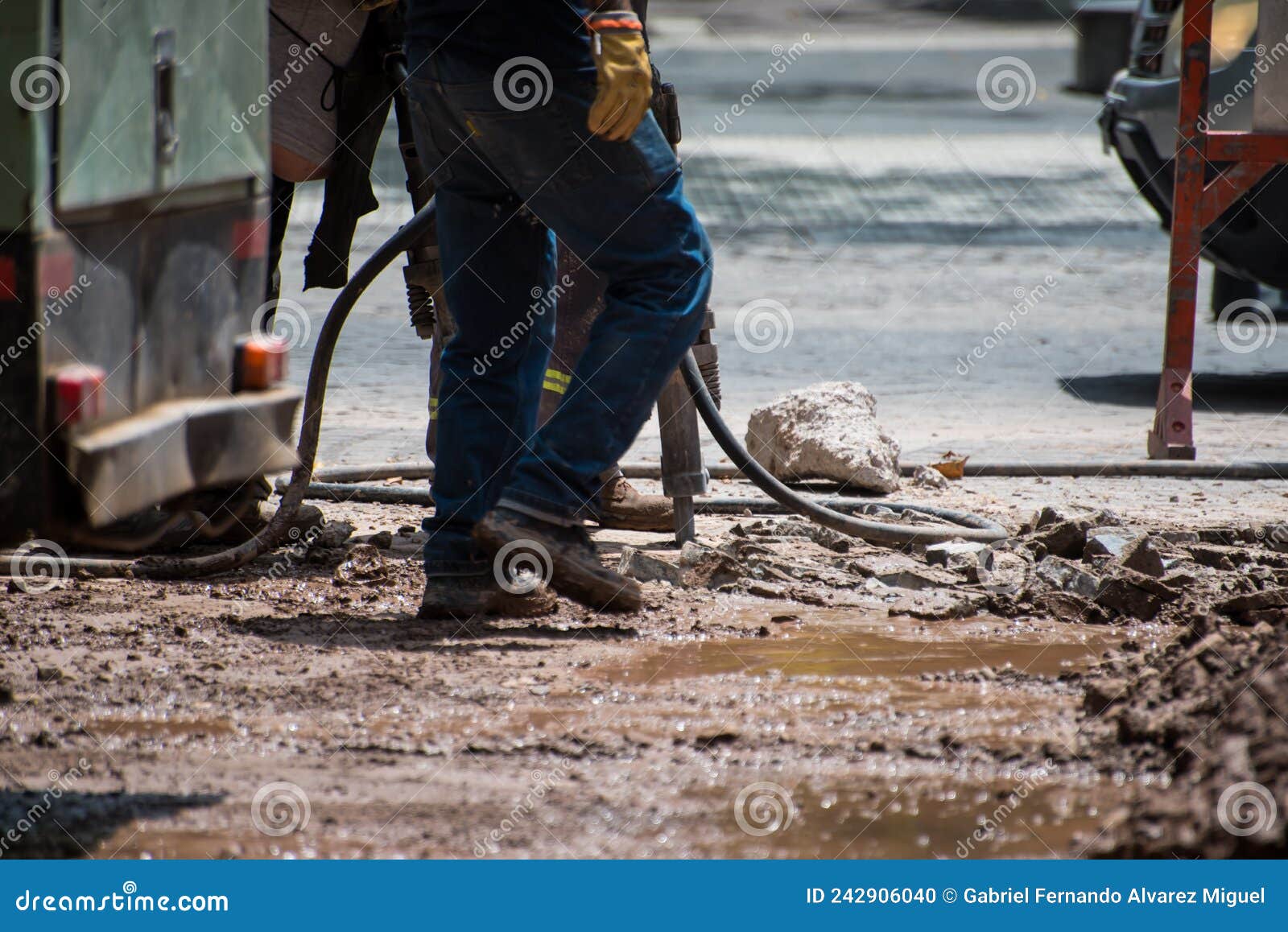 Construction Workers Walking through the Rubble of a Muddy Street Stock ...