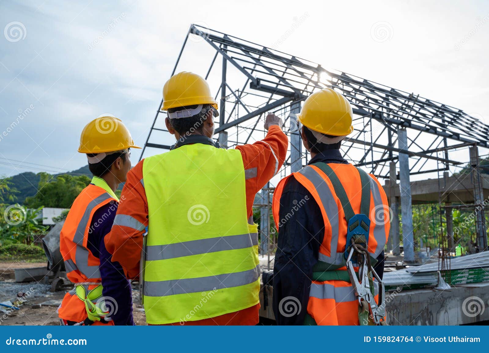 Construction Workers Wearing Safety Clothing and Discussing on ...