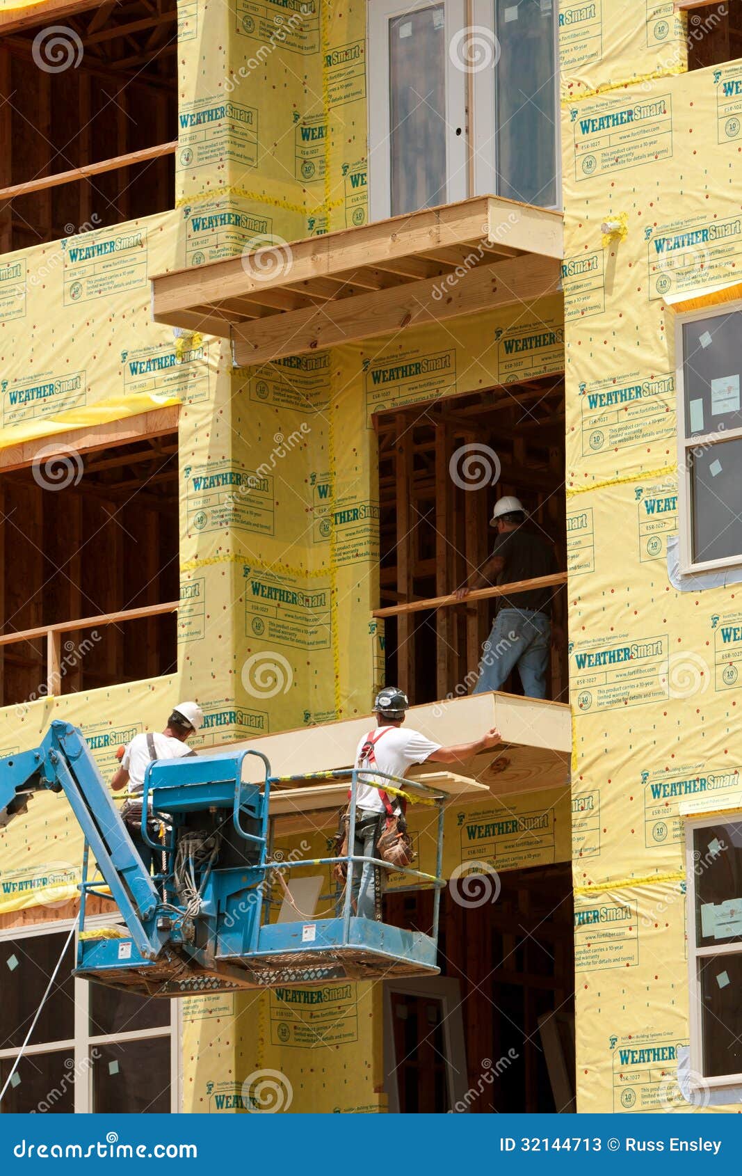 Construction Workers Work on Balcony at Condo Housing Development ...