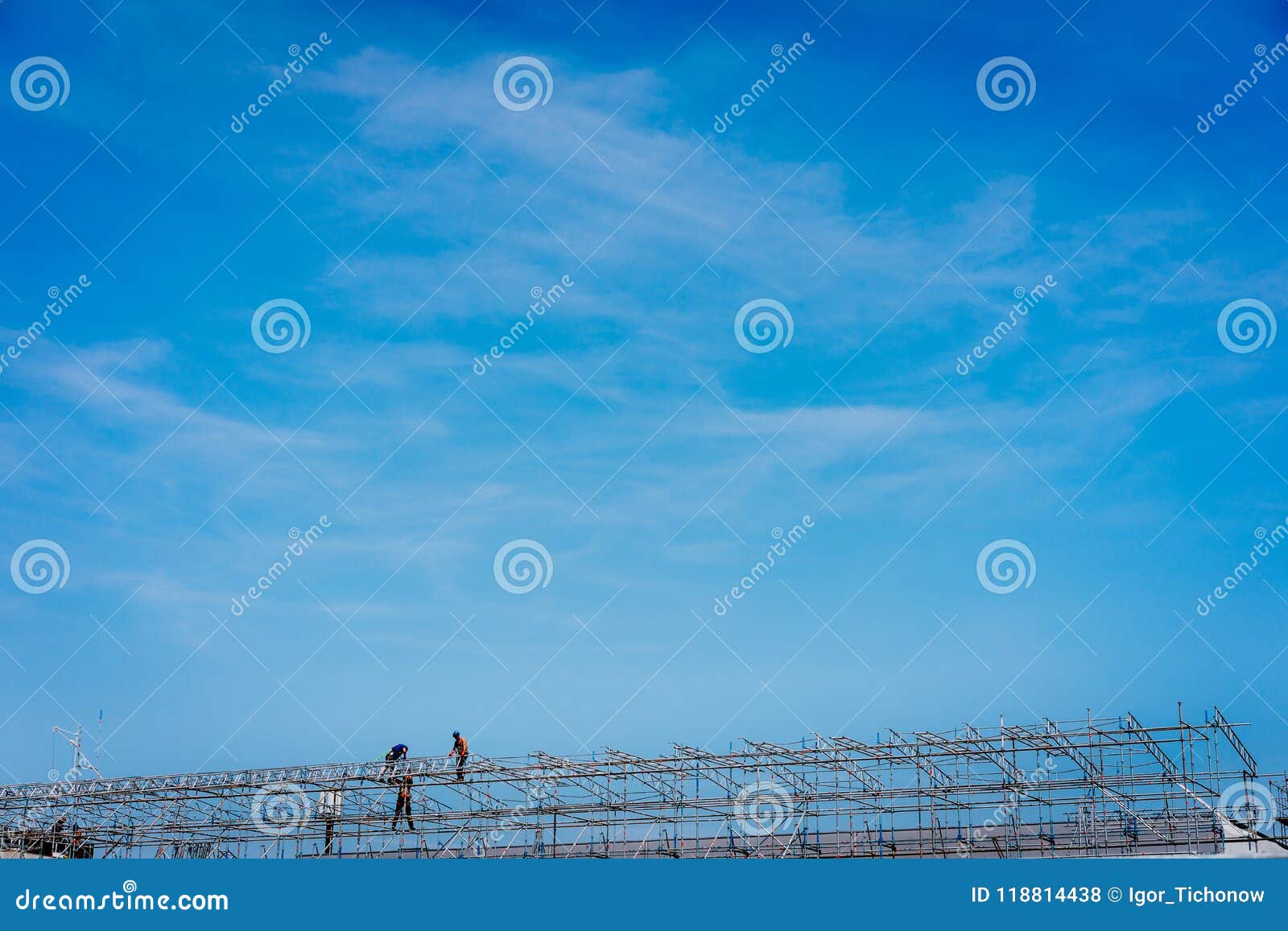 Construction Workers Working on Scaffolding. Blue Sky in Background ...