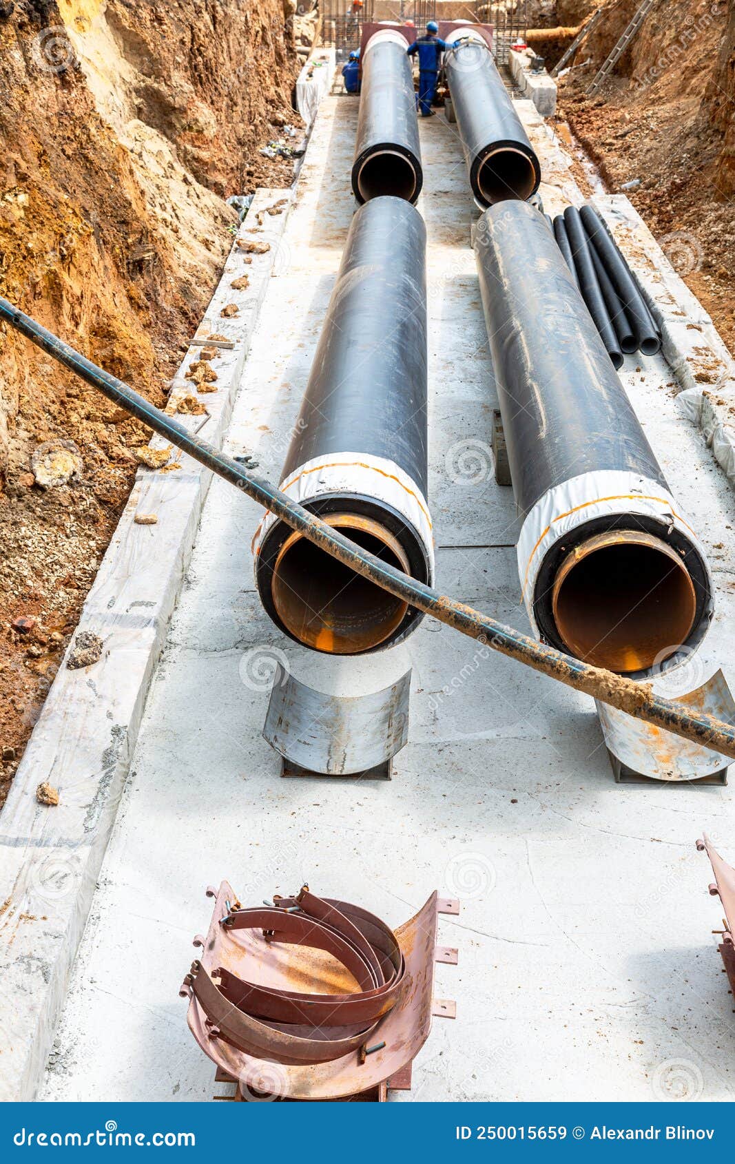 Construction Works on Large Iron Pipes at a Depth of Excavated Trench ...