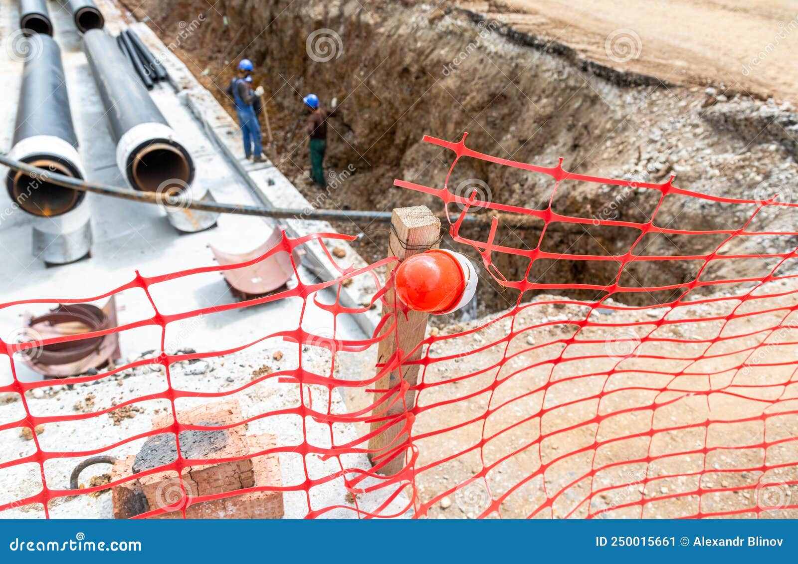 Construction Works on Large Iron Pipes at a Depth of Excavated Trench ...