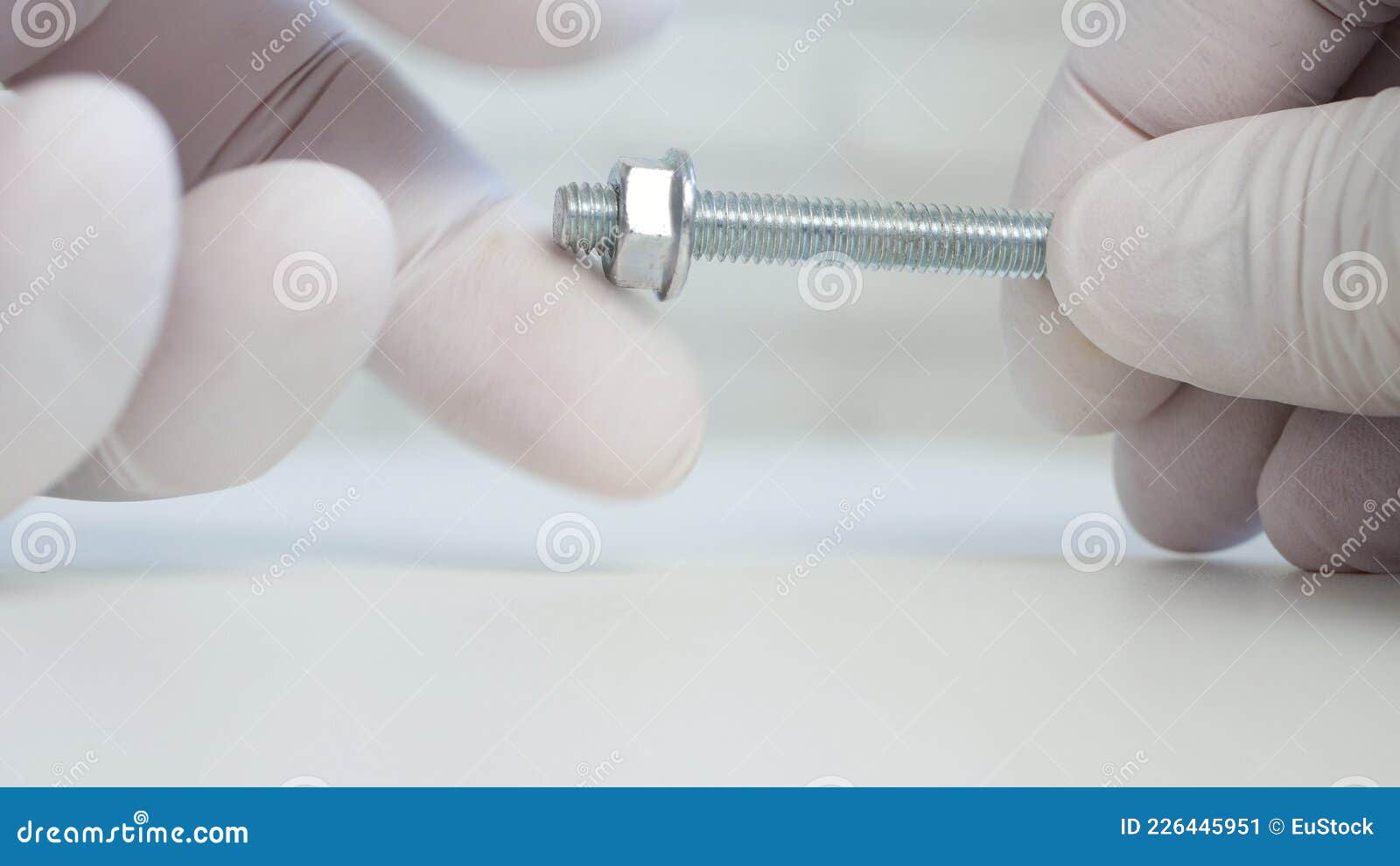 Constructor Screwing A Nut Onto A Metal Screw And Tightly Secure A Part ...