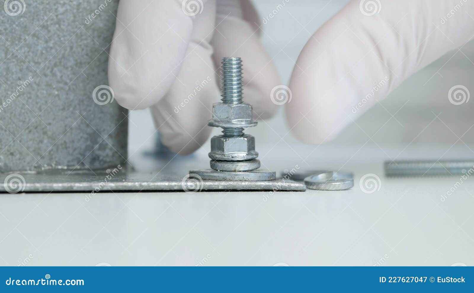 Constructor Screwing A Nut Onto A Metal Screw And Tightly Secure A Part ...