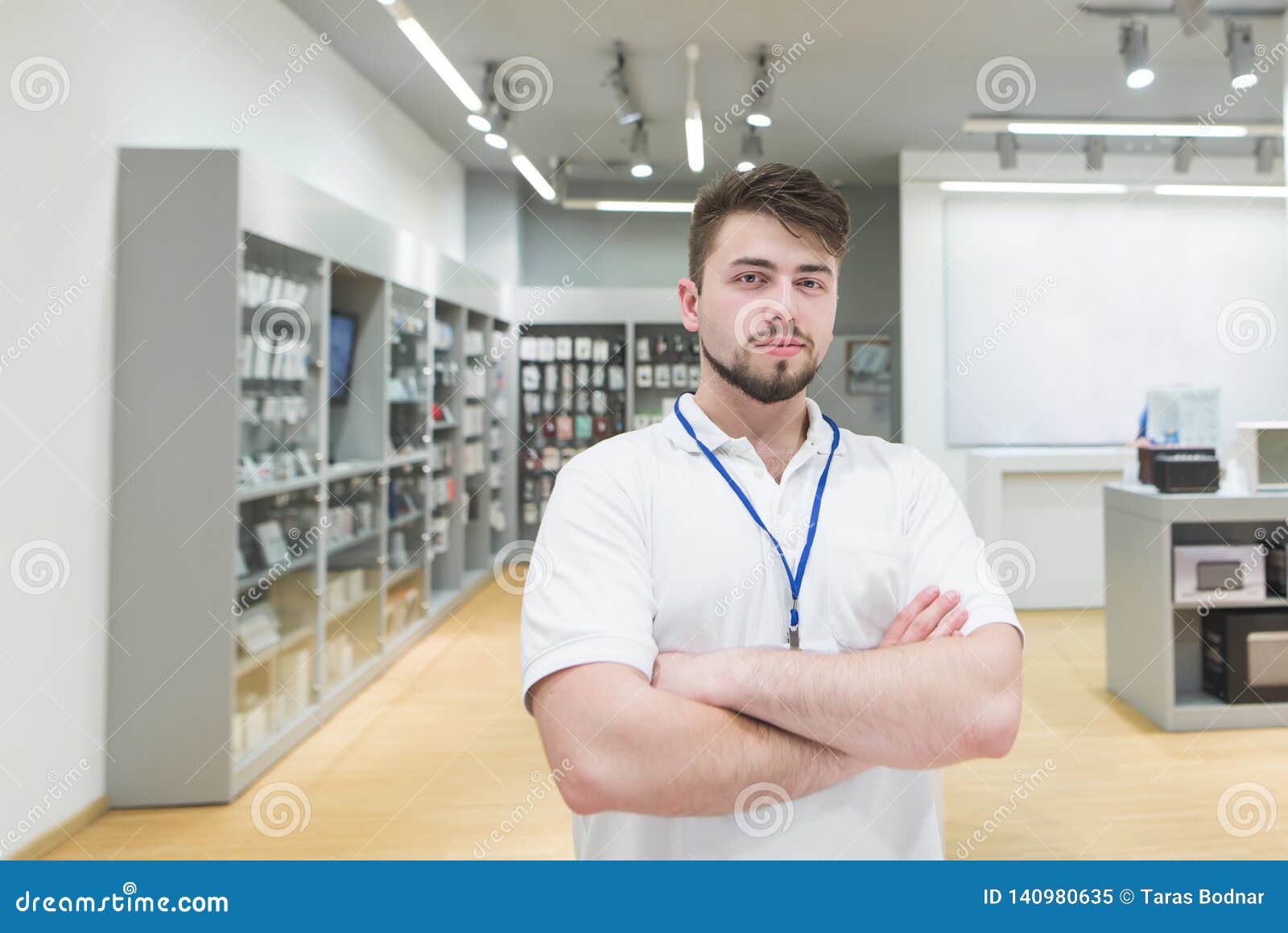 Consultant Poses To the Camera on the Background of a Light Electronics ...