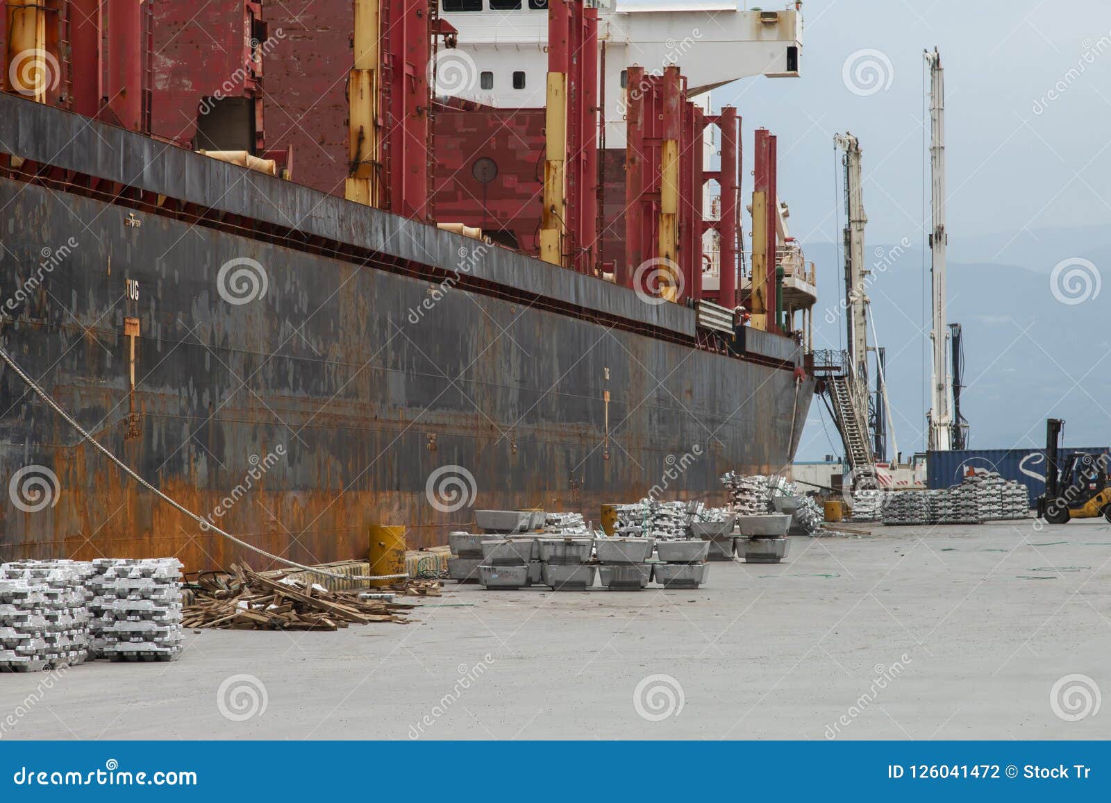 The Container Is Being Lowered From The Ship That Is Approaching The ...