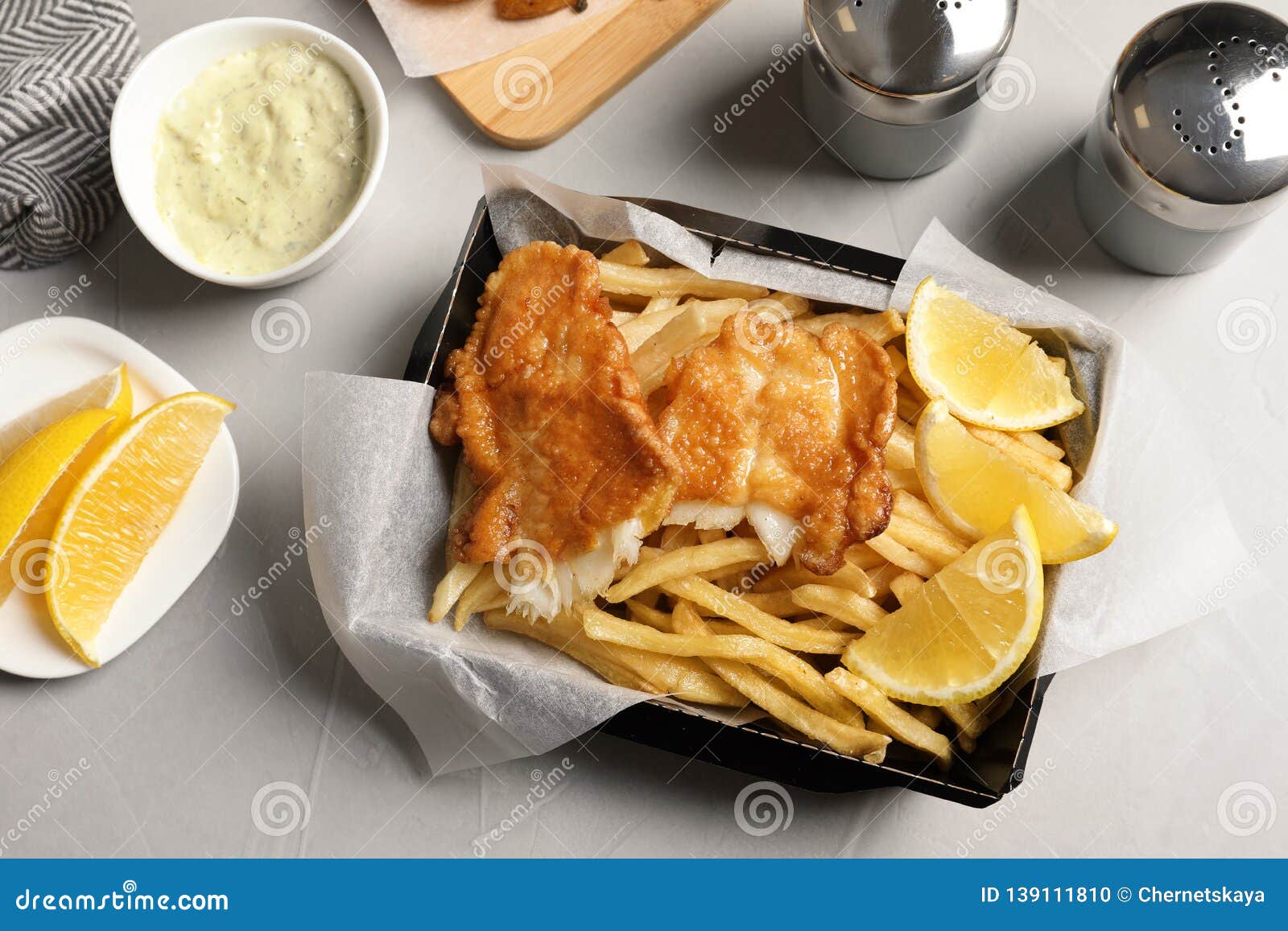 Container With British Traditional Fish And Potato Chips On Light ...