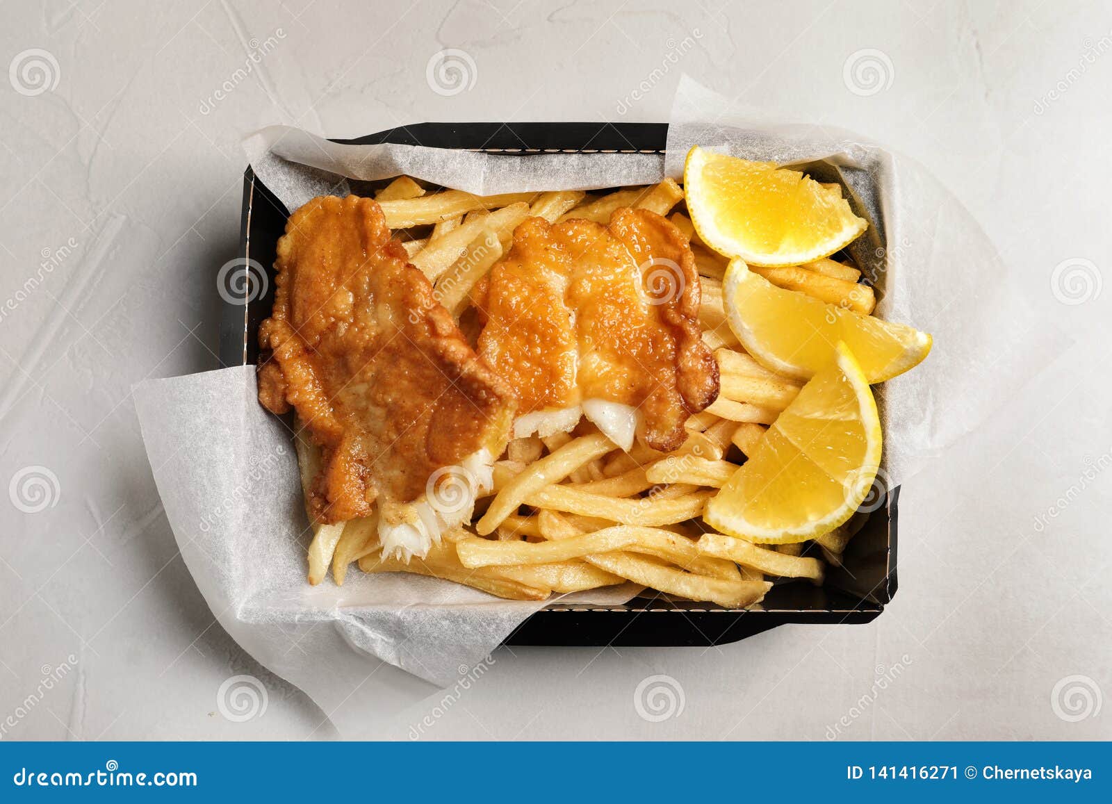 Container With British Traditional Fish And Potato Chips On Light ...
