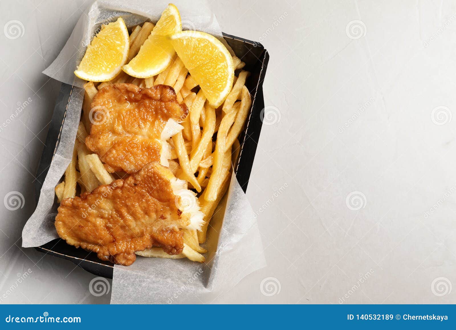 Container With British Traditional Fish And Potato Chips On Light ...
