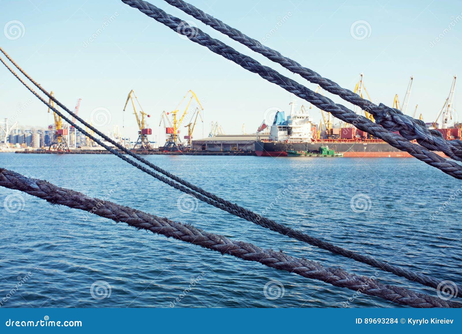 Container Cargo Ship with Working Crane Bridge in Shipyard Background ...