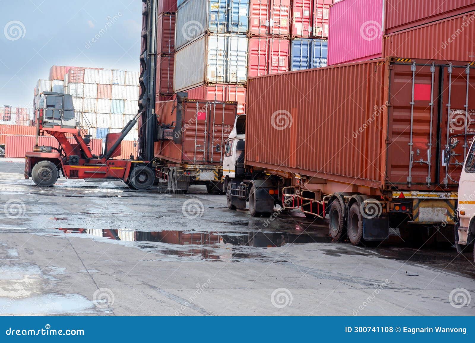 A Container Forklift Sits Behind a Stack of Containers Stock Photo ...