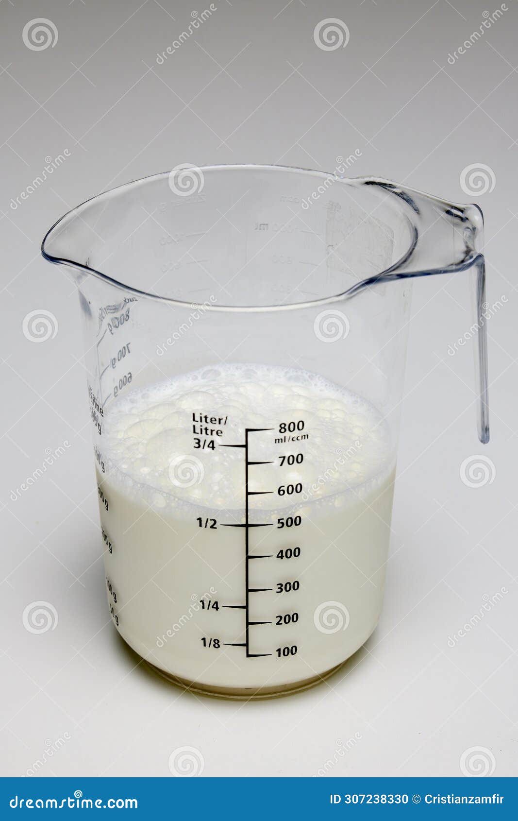 A Container with Graduated Milk Stock Photo - Image of liquid, lactose ...