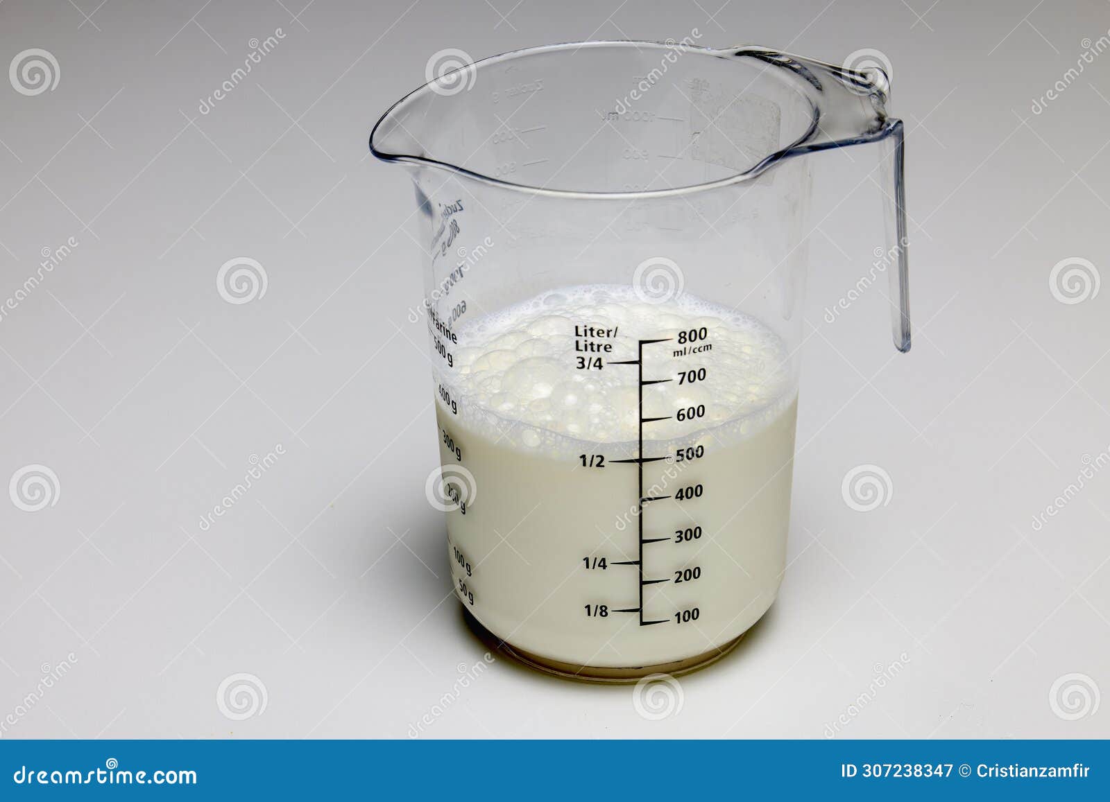 A Container with Graduated Milk Stock Image - Image of liter, scale ...