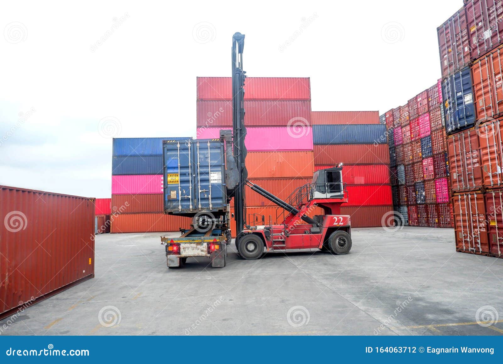 Container Handlers Put Containers into Work Trucks in the Harbor Stock ...