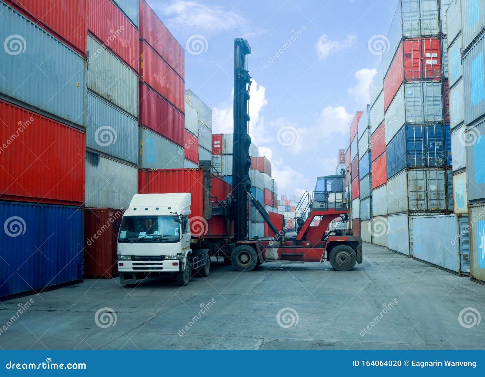 Container Handlers Put Containers into Work Trucks in the Harbor Stock ...