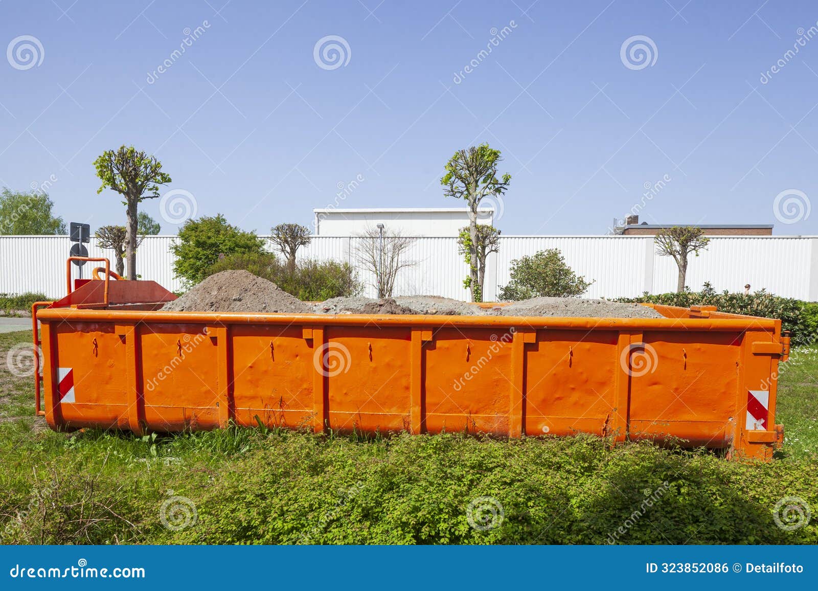 Container, Orange Skip for Building Rubble Standing on a Meadow Stock ...