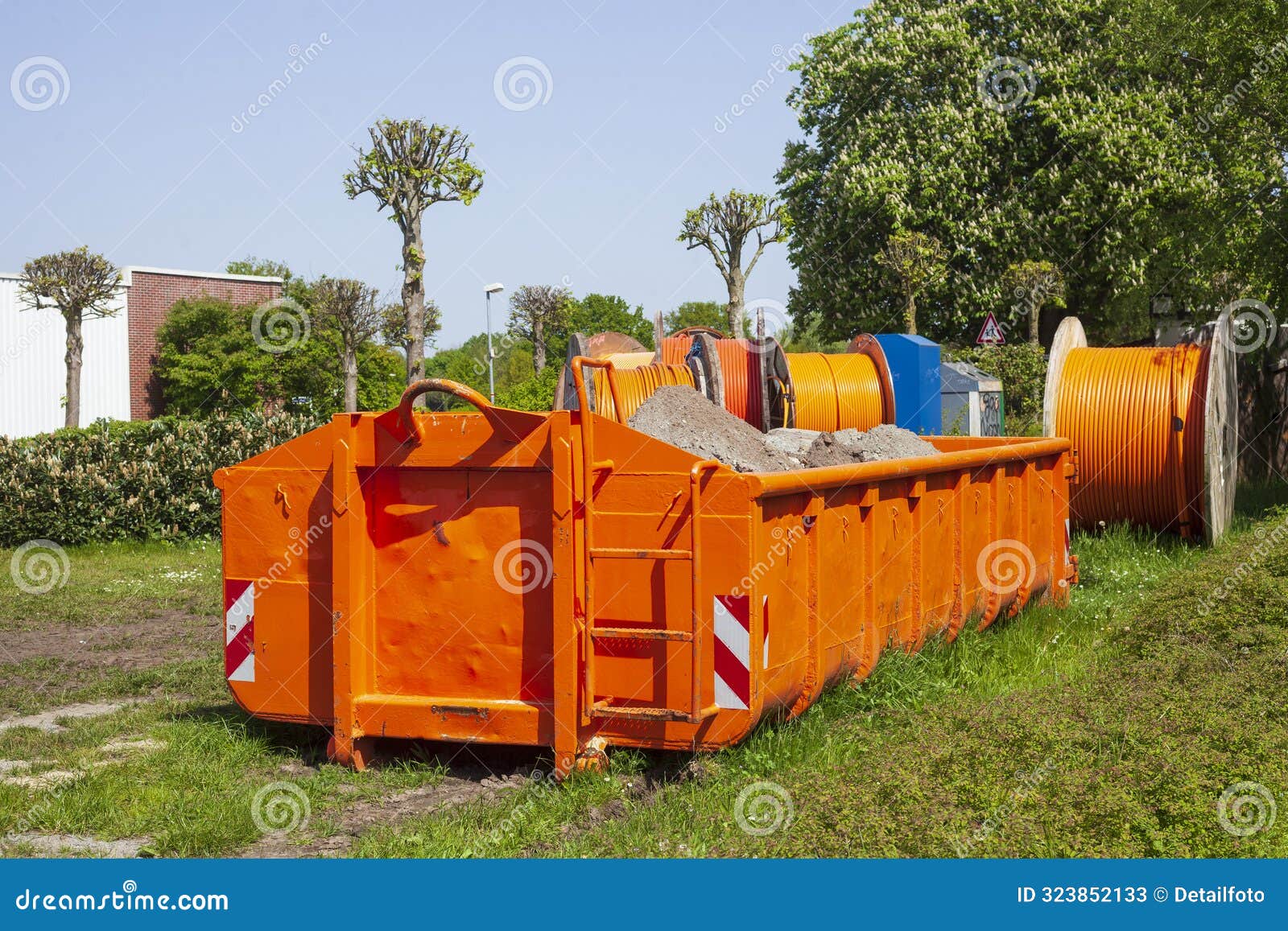 Container, Orange Skip for Building Rubble Standing on a Meadow Stock ...