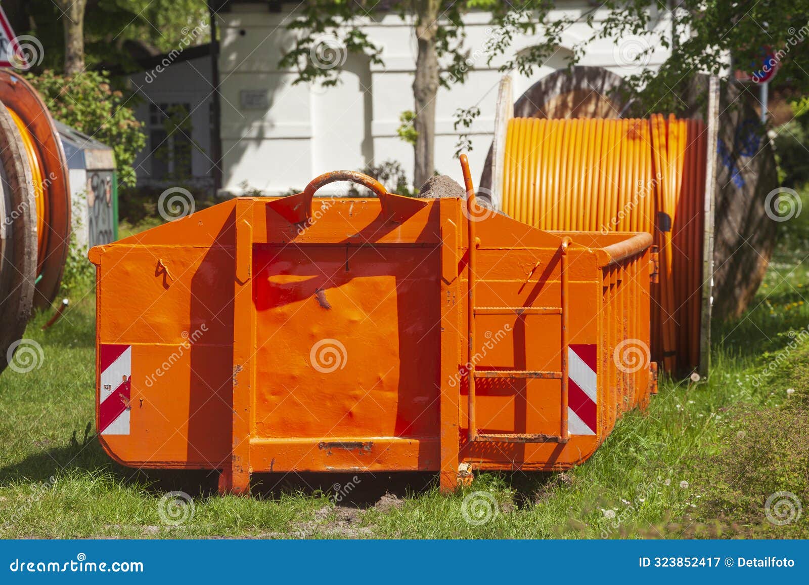 Container, Orange Skip for Building Rubble Standing on a Meadow Stock ...