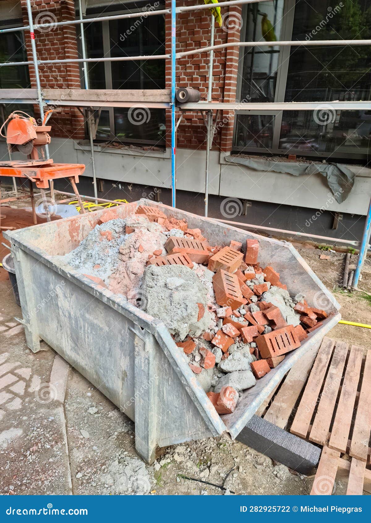 A Container with Rubble in Front of a Construction Site Stock Photo ...