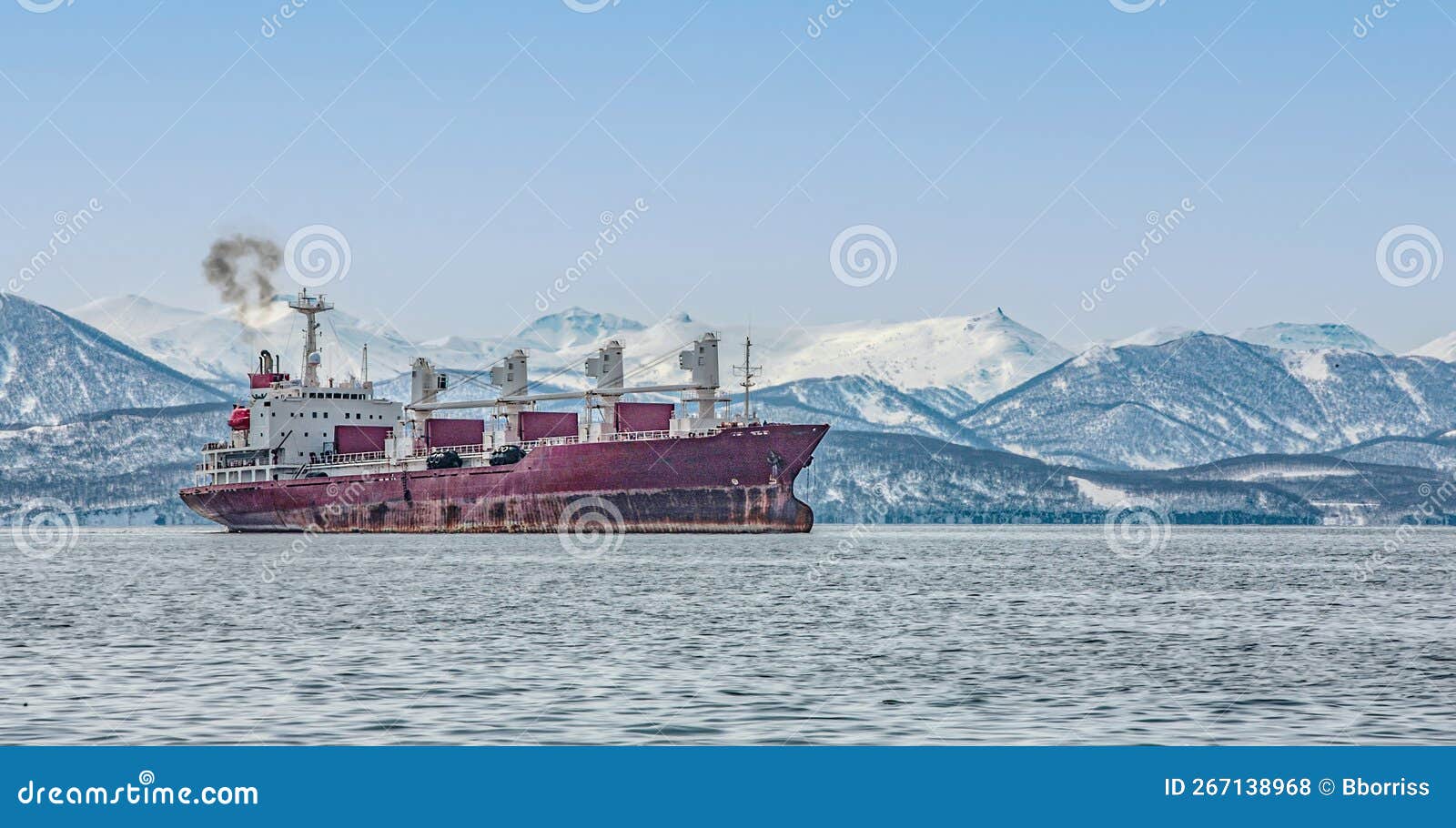 Container Ship in the Bay Opposite the Snow-capped Mountains on the ...