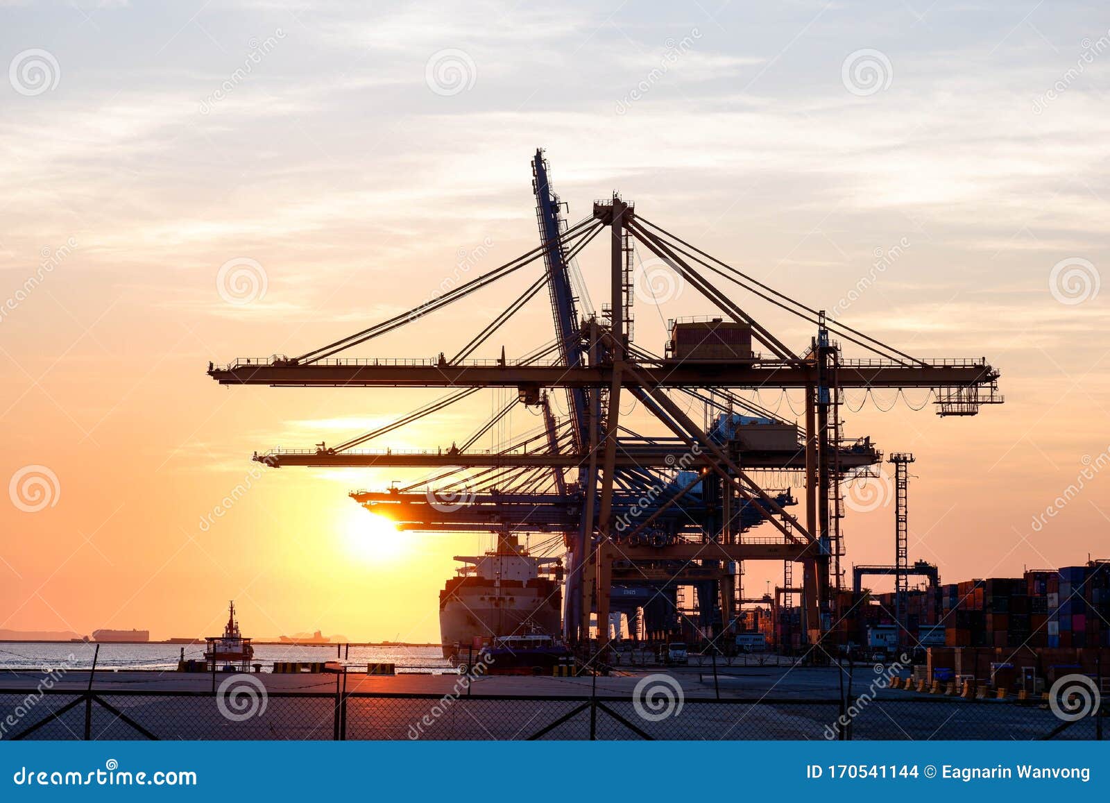 Container Ship with Cranes for Loading Goods in the Port in the Evening ...