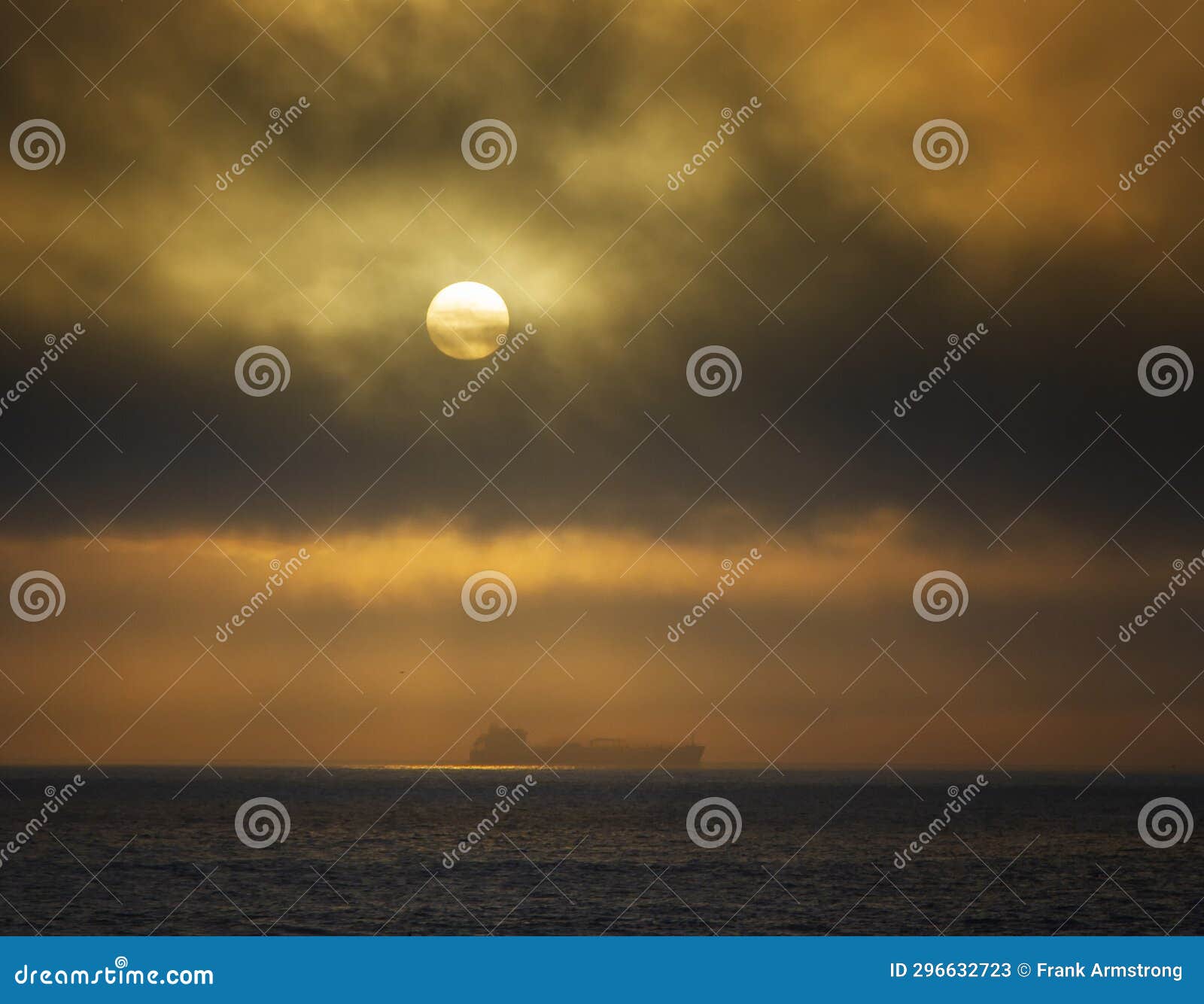 Container Ship in the Distance at Sunset with Sun Visible Stock Image ...