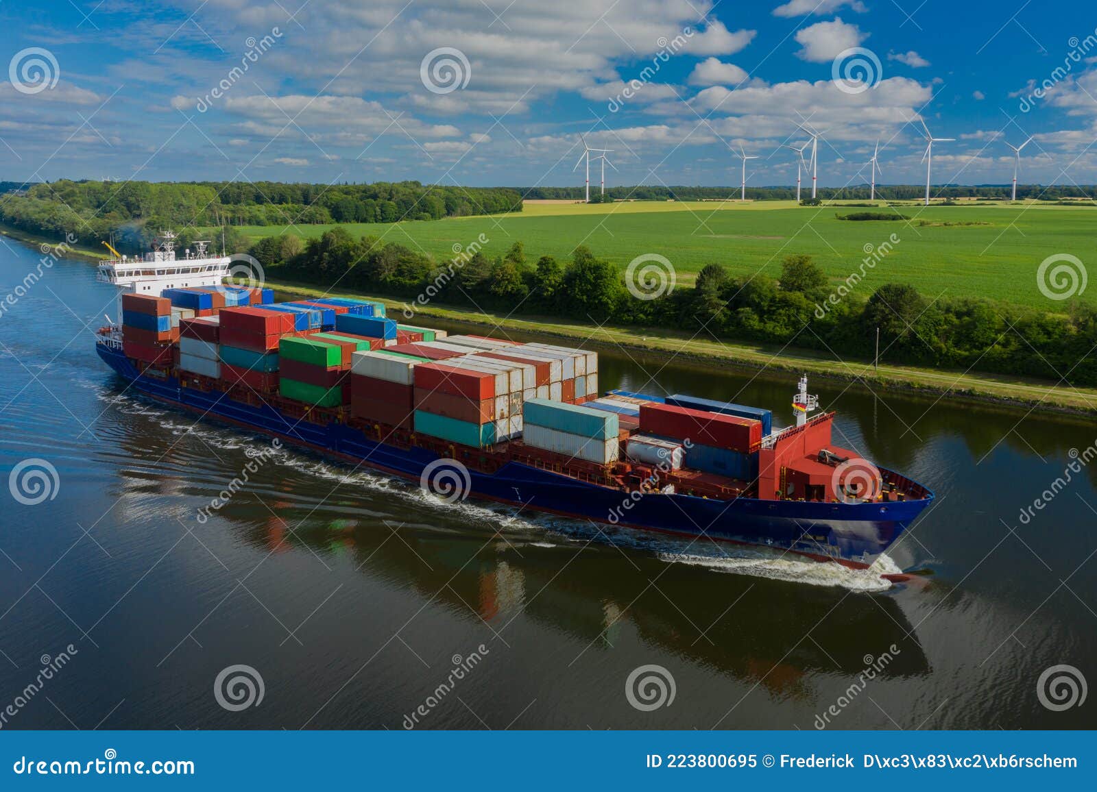 Container Ship on the Kiel Canal and Windmill on the Background. Stock ...