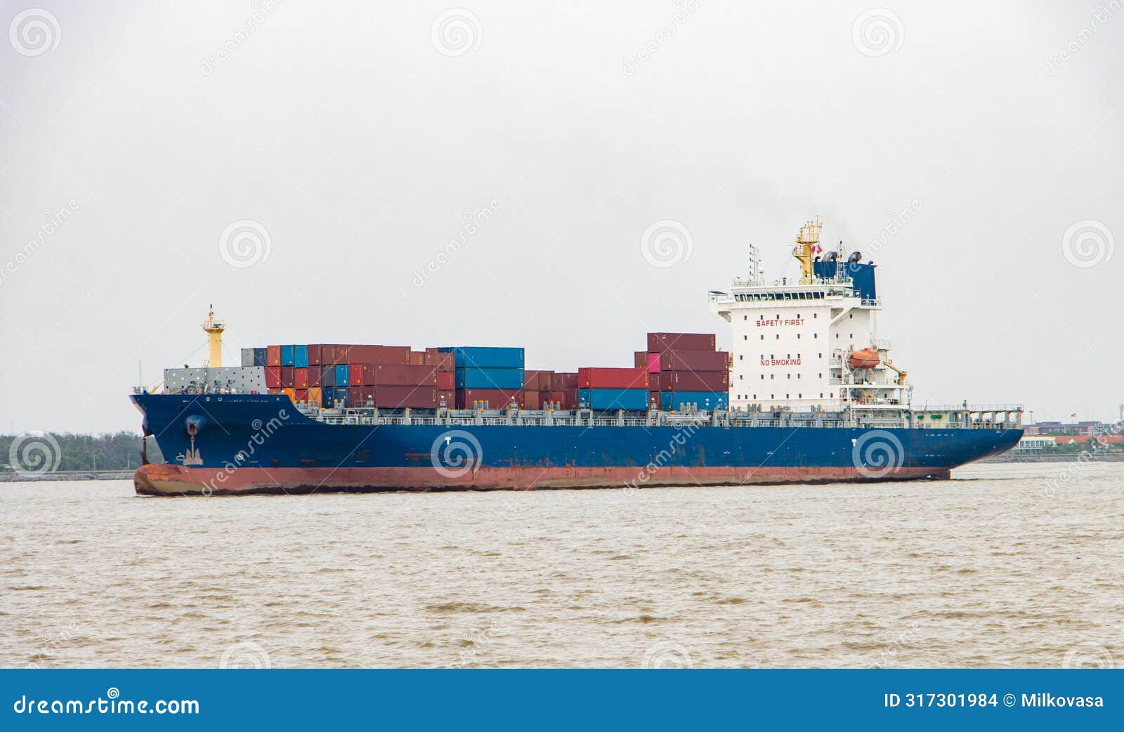 The Container Ship Loaded of Containers Sail beside a Seashore Stock ...