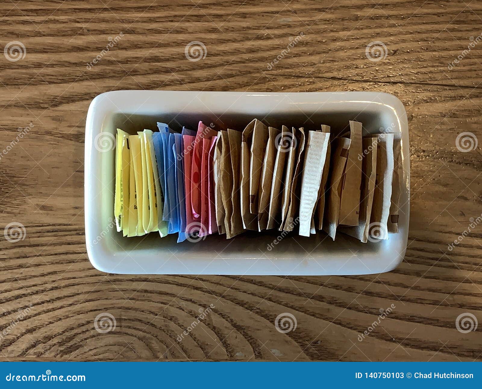 Container of Sugar Nd Sugar Substitute Packets on a Restaurant Table ...