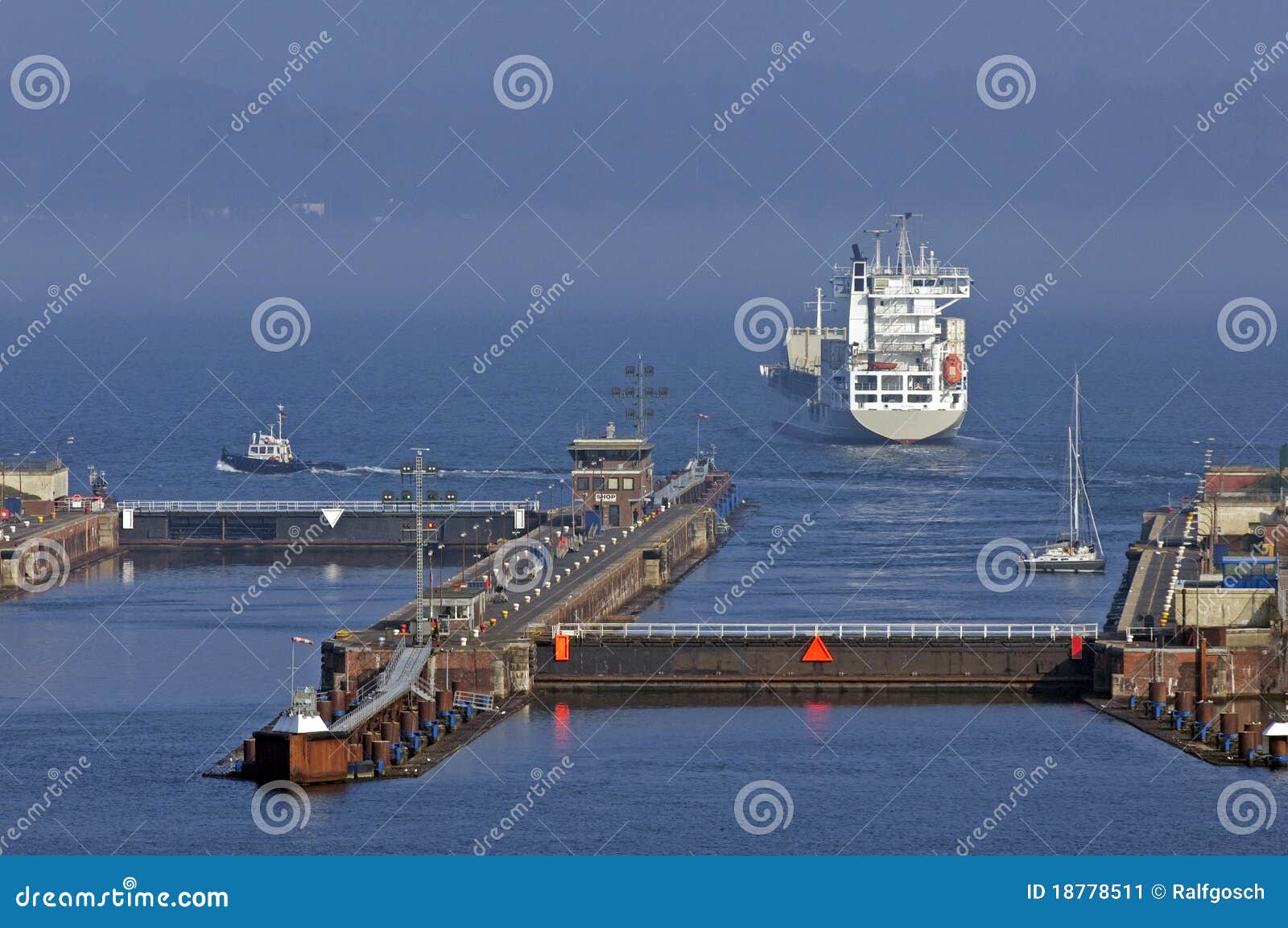 Container Vessel Berthing At An Industrial Port. Tugboat Push Large ...