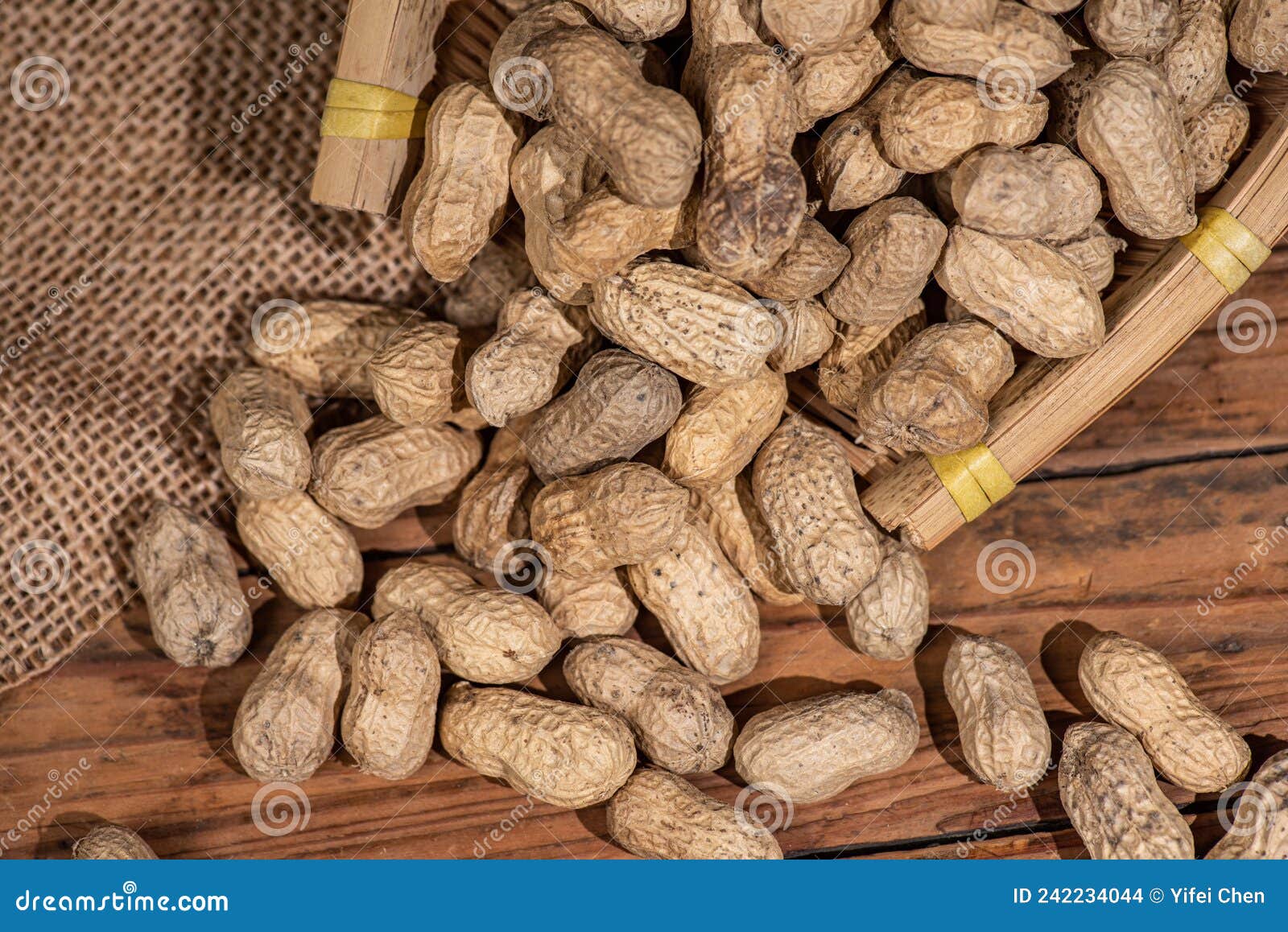 The Container on the Wood Grain Table is Full of Peanuts Stock Photo ...