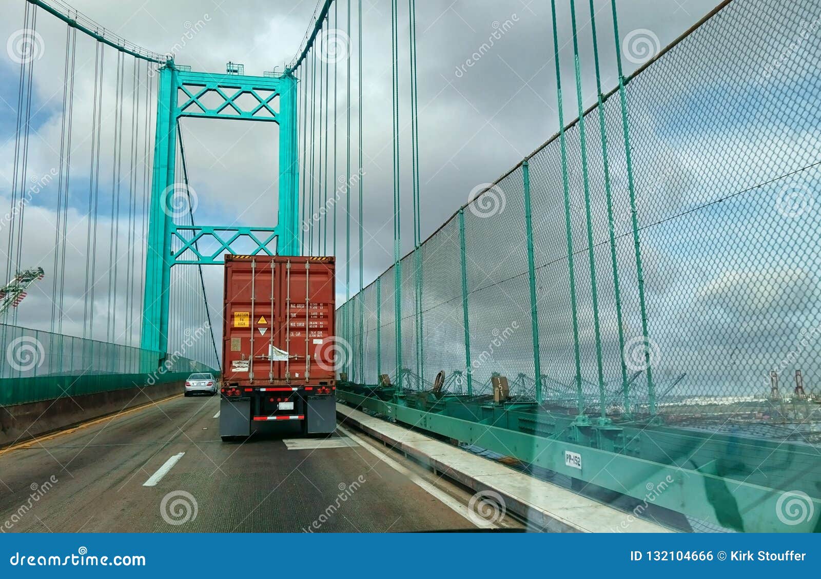 A Truck Pulling a Cargo Container Drives Over the Saint Thomas Bridge ...