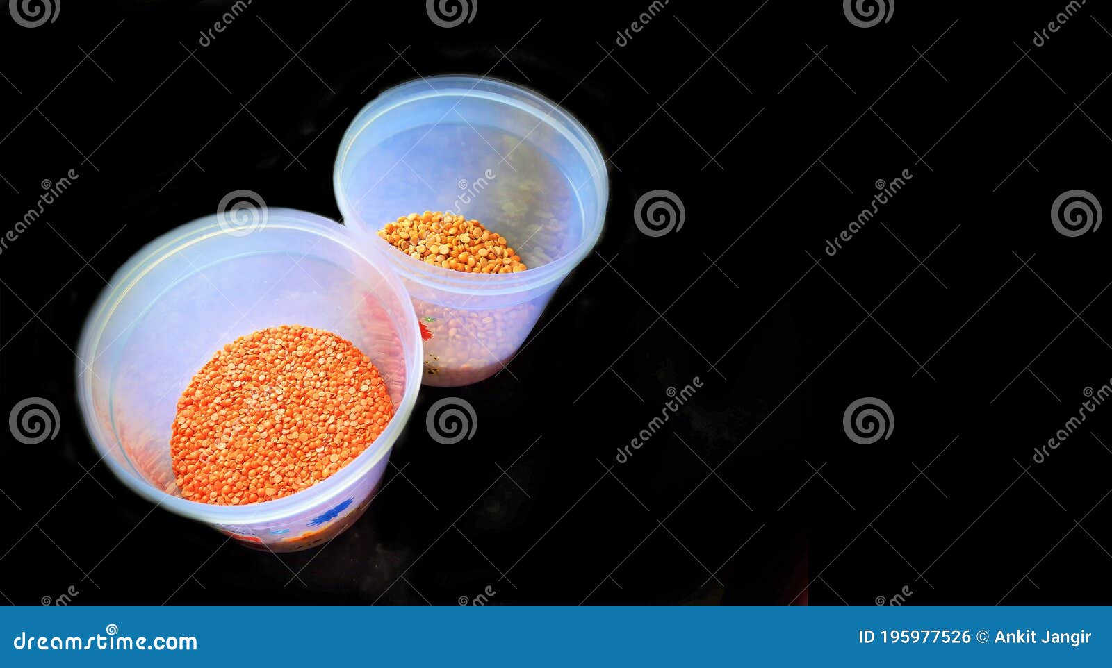 Containers of Red Lentil or Masoor Dal Isolated in Black Stock Photo ...