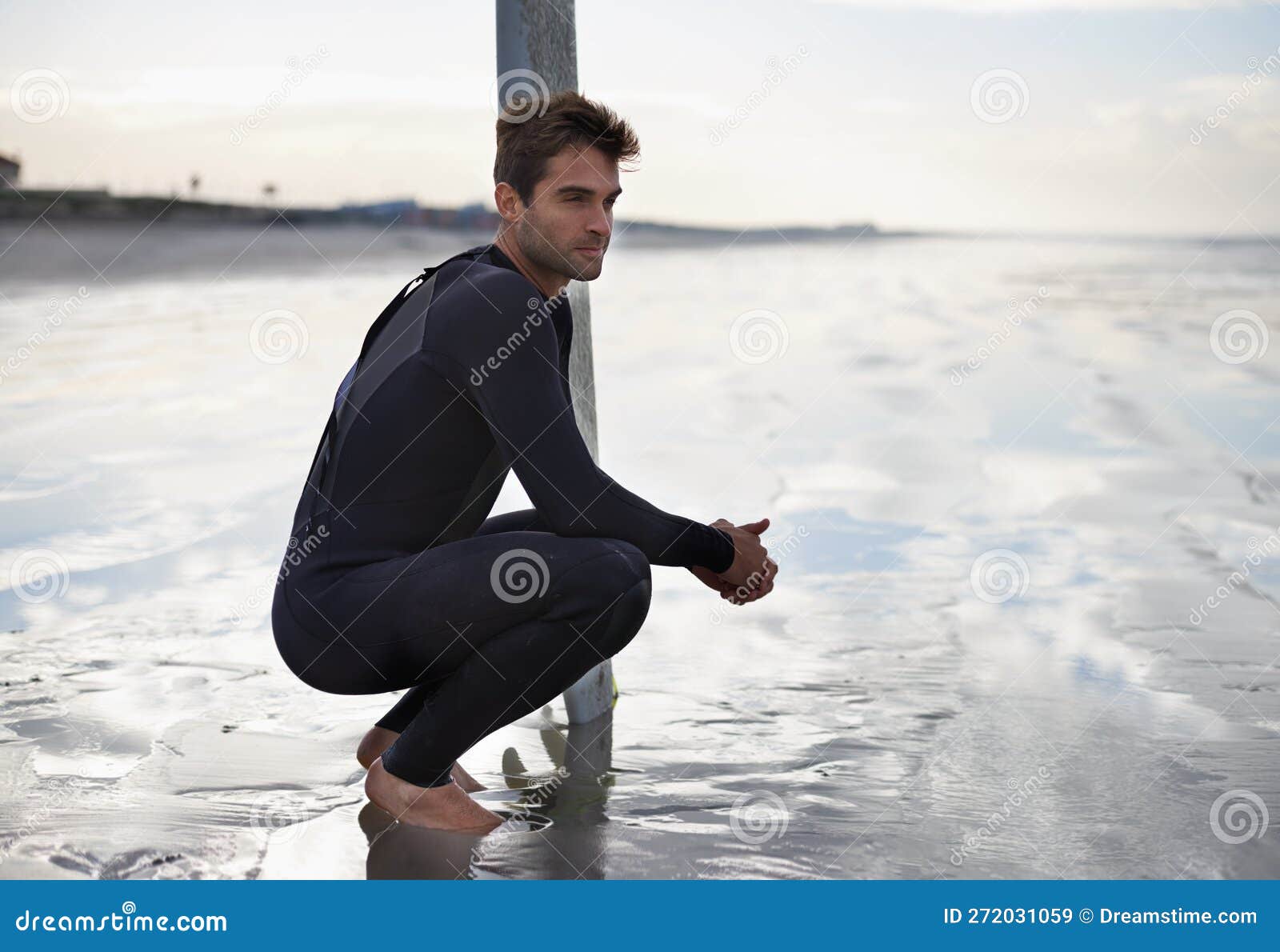 Contemplating Going in for Another Wave. a Handsome Young Man Crouching ...