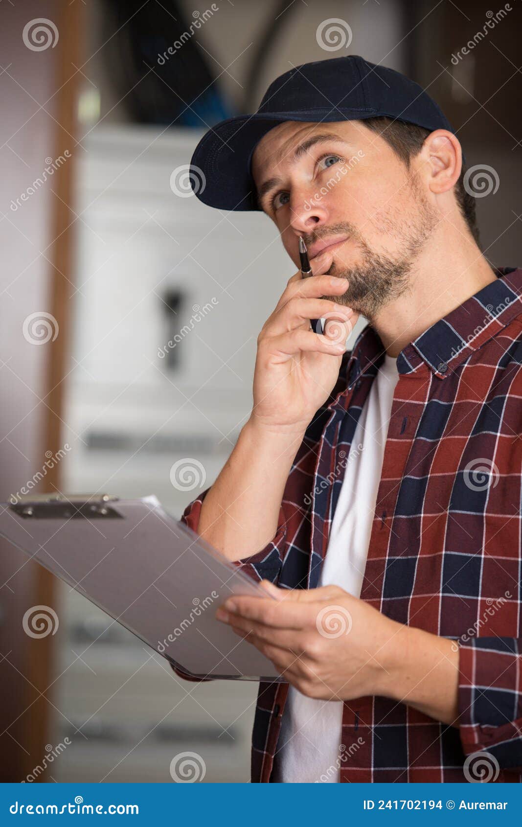 Contemplative Male Inspector Holding Clipboard Stock Photo - Image of ...