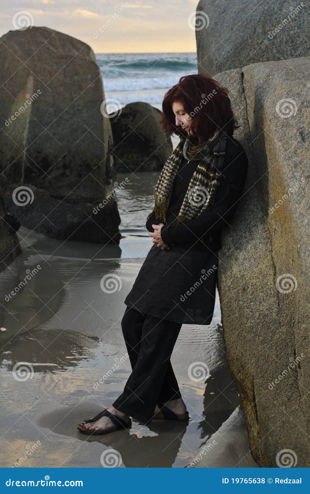 Contemplative Woman by Seaside Rocks Stock Photo - Image of ...