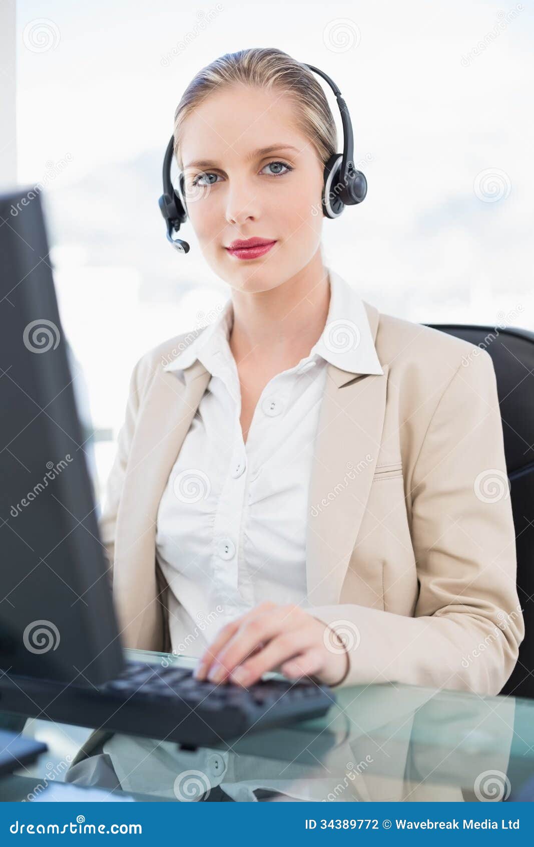 Content Blonde Call Centre Agent Working on Computer Stock Photo ...