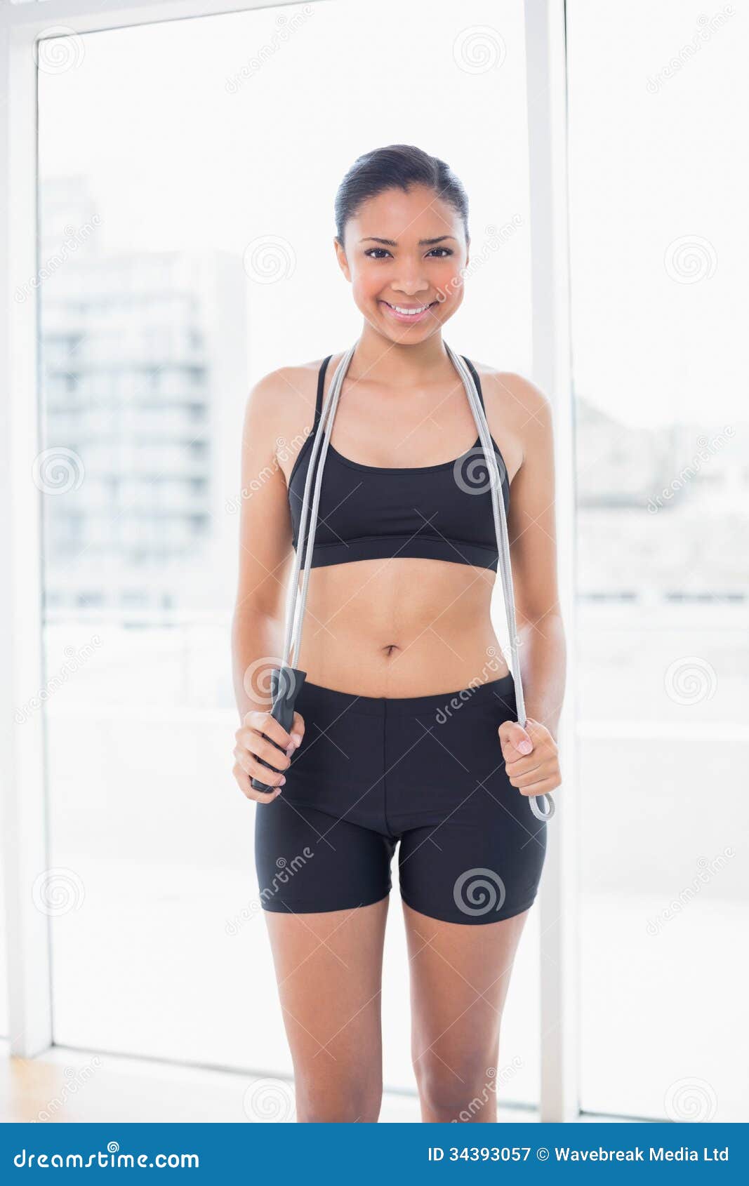 Content Dark Haired Model In Sportswear Holding A Skipping Rope Stock