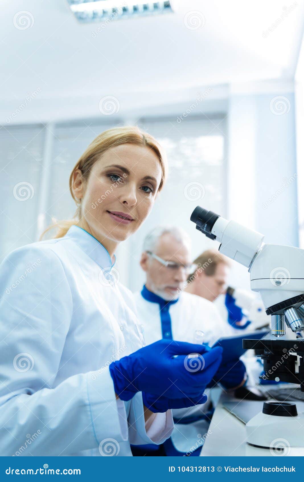 Content Scientist Sitting at a Microscope Stock Image - Image of ...