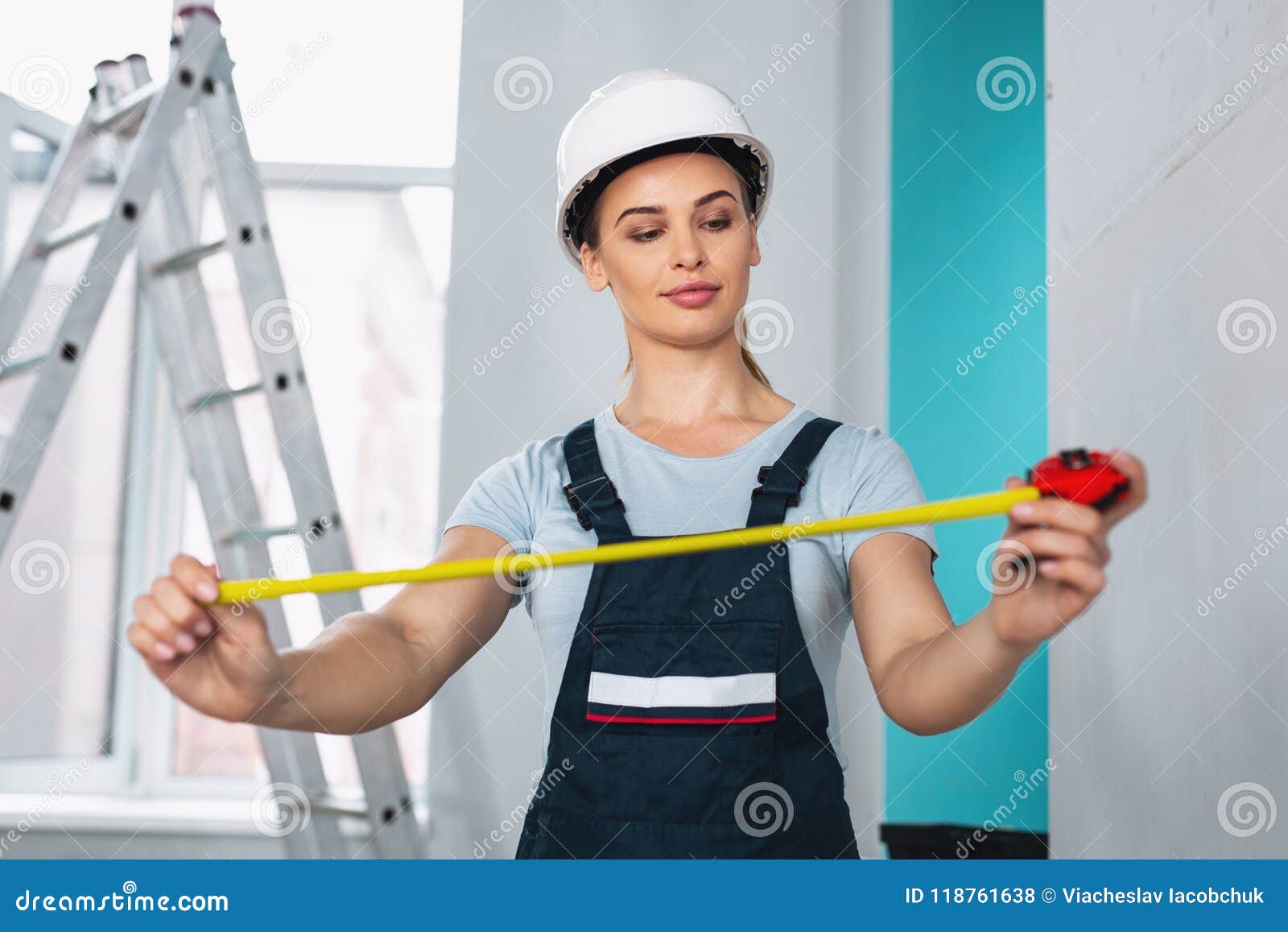 Content Skilled Builder Holding a Measuring Tape Stock Photo - Image of ...