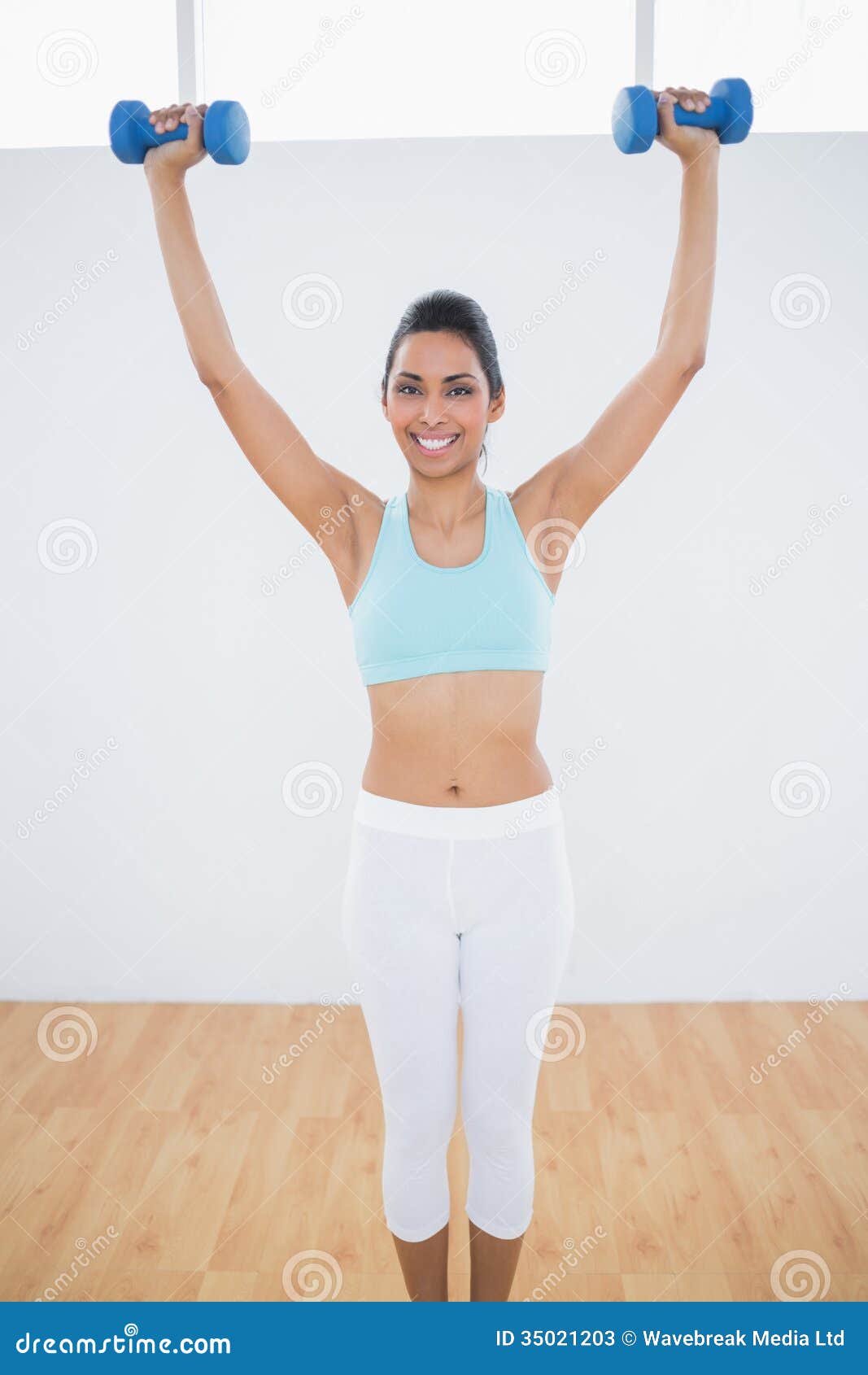 Content Slender Woman Lifting Blue Dumbbells Stock Image - Image of ...
