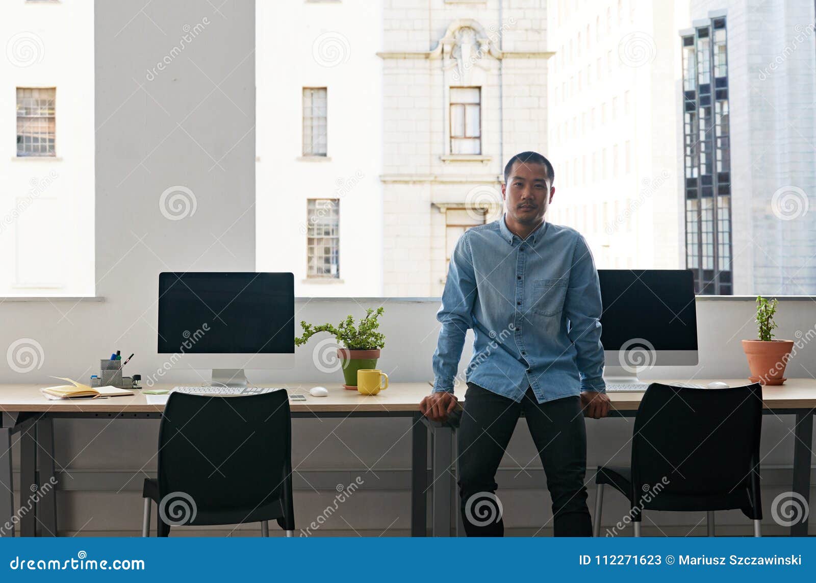 Young Asian Designer Standing Alone In A Modern Office Stock Image ...