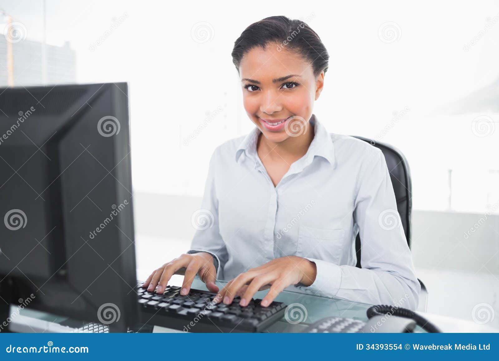 Content Young Dark Haired Businesswoman Typing on Her Computer Stock ...