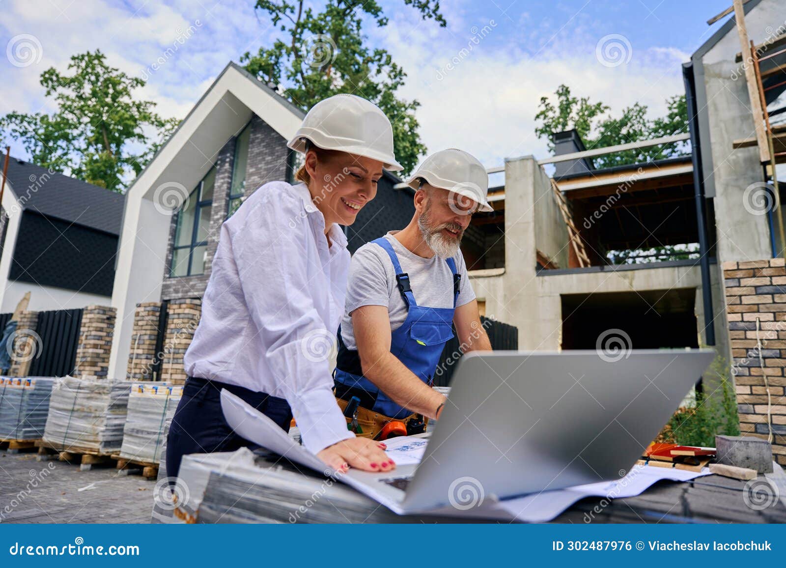 Construction Specialists Analyzing Site Development Plans Outdoors ...